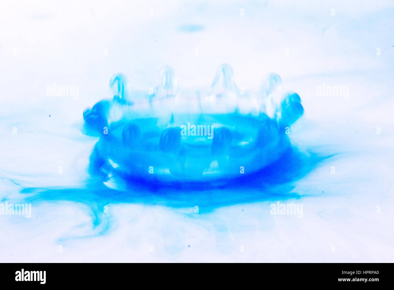 Colorful paint drop splashing on black a background Stock Photo - Alamy