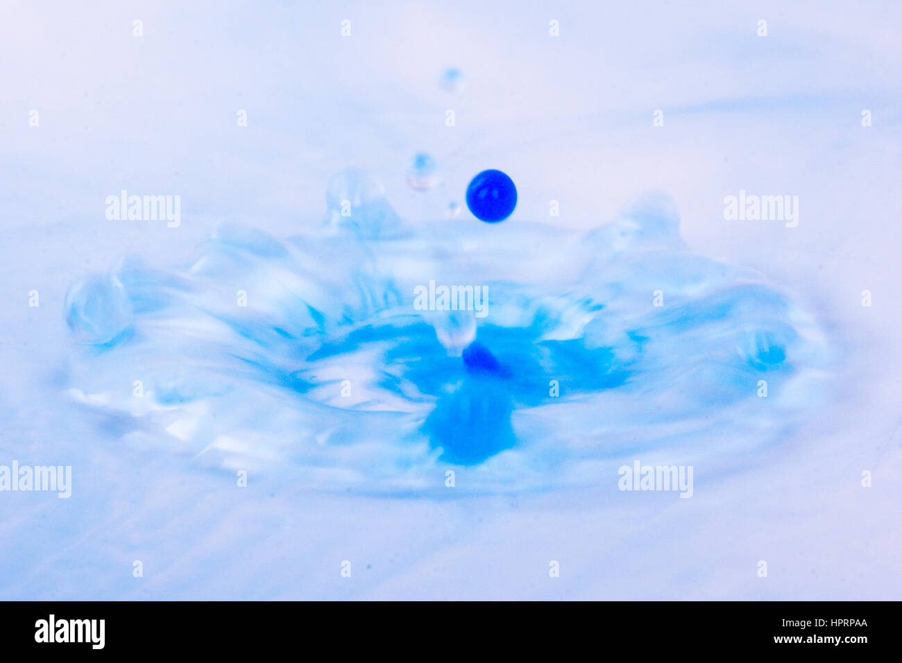 Colorful paint drop splashing on black a background Stock Photo - Alamy