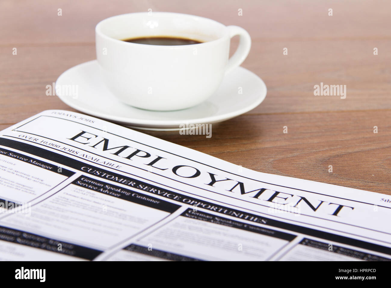 Searching for a new job or employment in a newspaper Stock Photo - Alamy