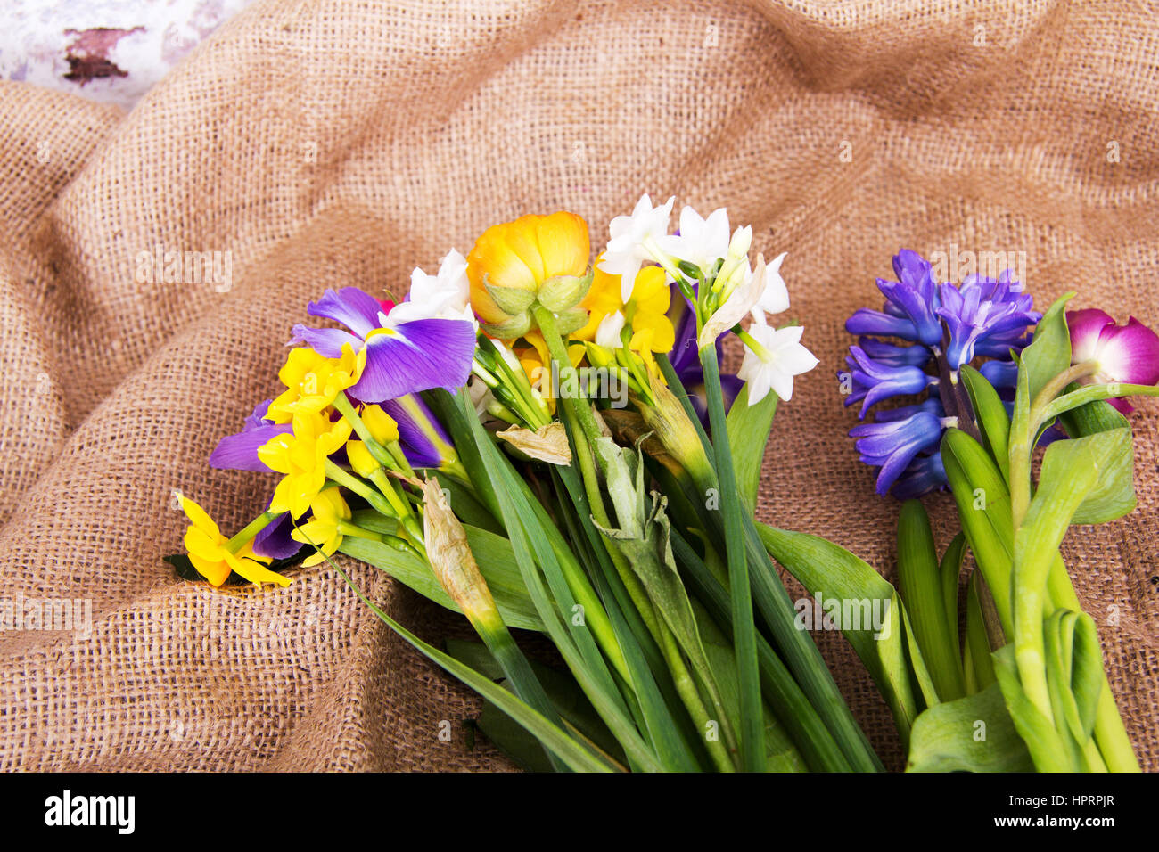 Spring cut flower arrangement against a rustic background Stock Photo ...