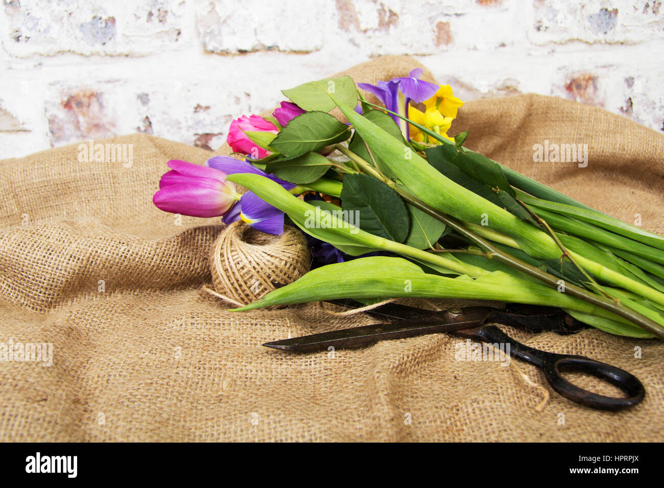 Spring cut flower arrangement against a rustic background Stock Photo ...