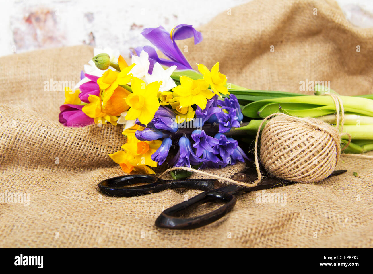 Spring cut flower arrangement against a rustic background Stock Photo ...