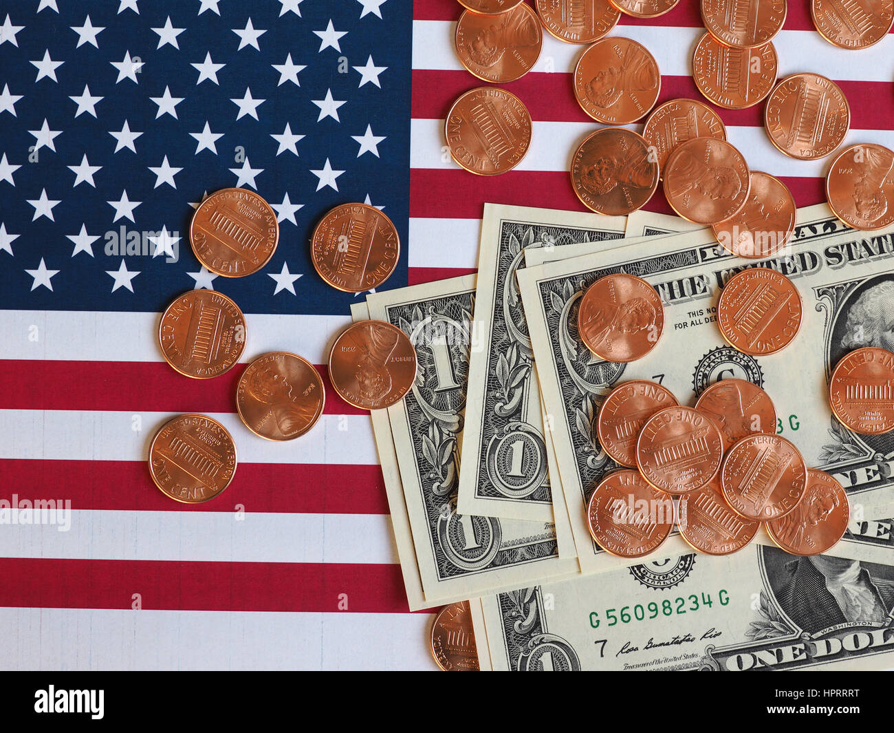One Dollar banknotes and One Cent coins (USD) currency money over the ...