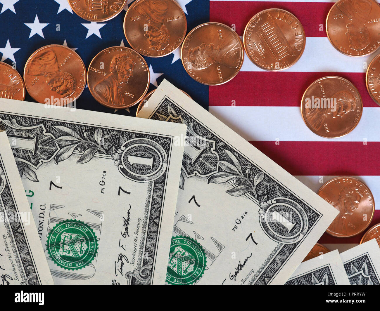 One Dollar banknotes and One Cent coins (USD) currency money over the ...