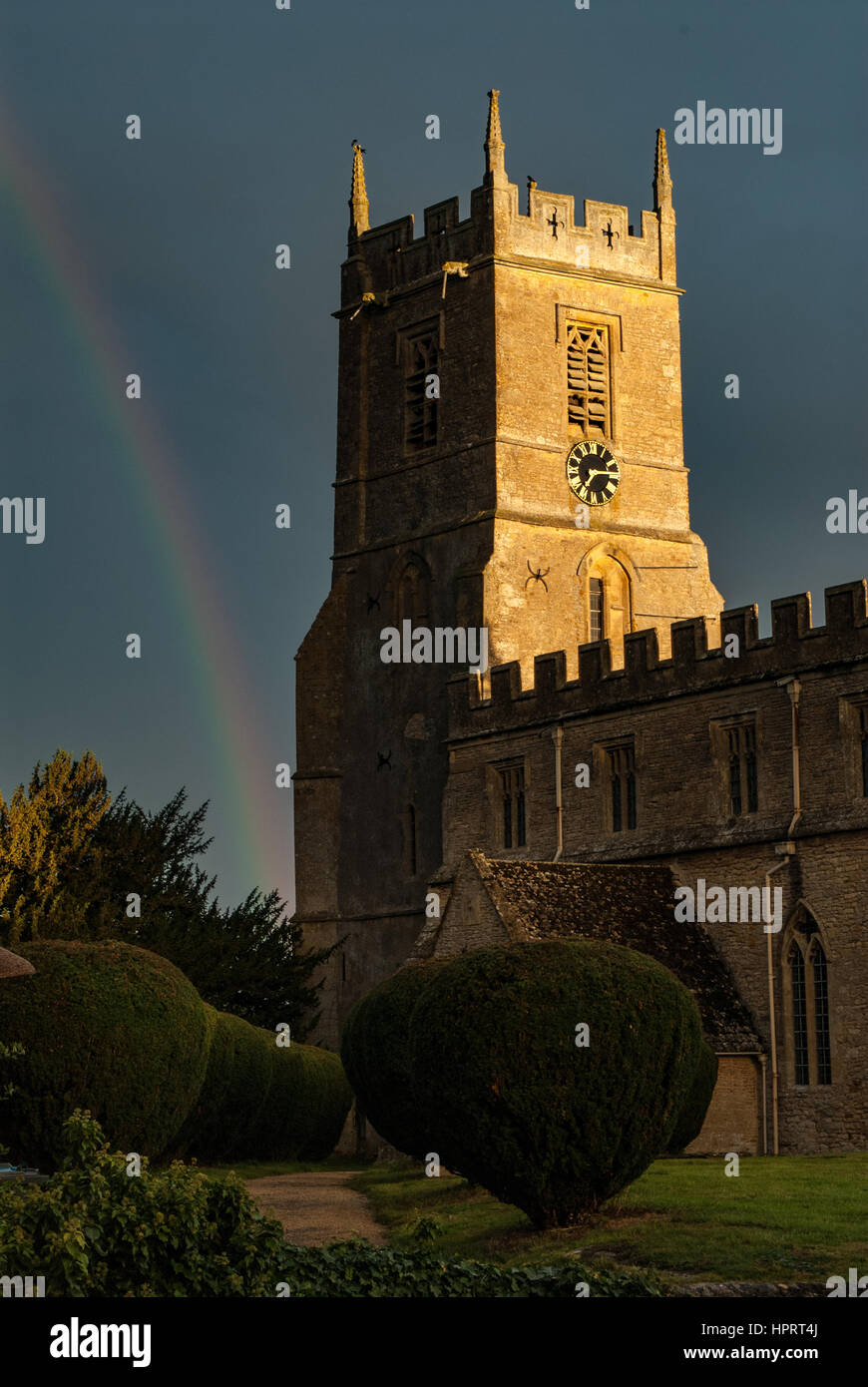 Rainbow on a stormy day at the church of St Peter and St Paul at Long ...