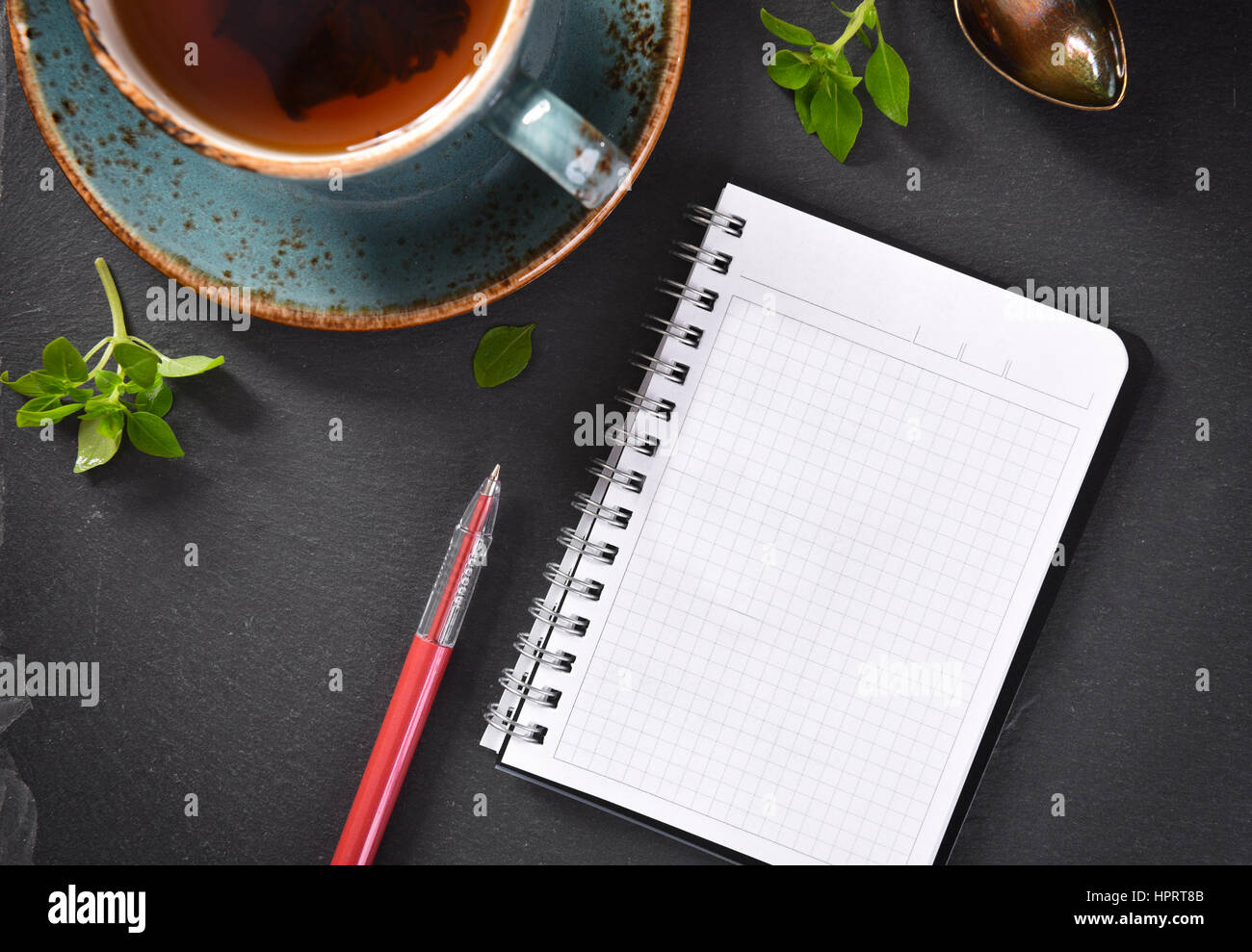 Open recipe book on slate board. Top view Stock Photo - Alamy