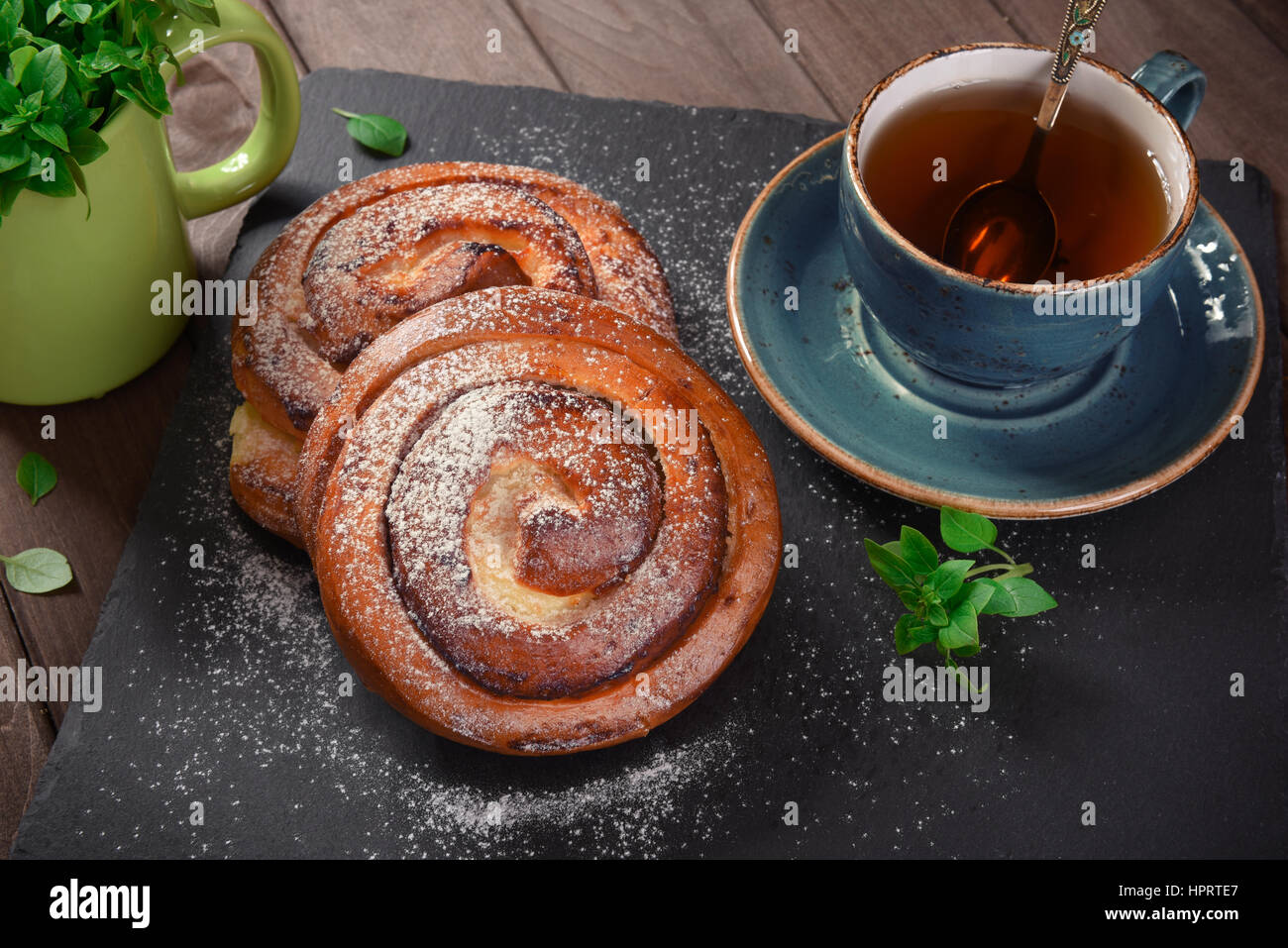 Homemade cream roll and cup of tea on rustic background Stock Photo - Alamy