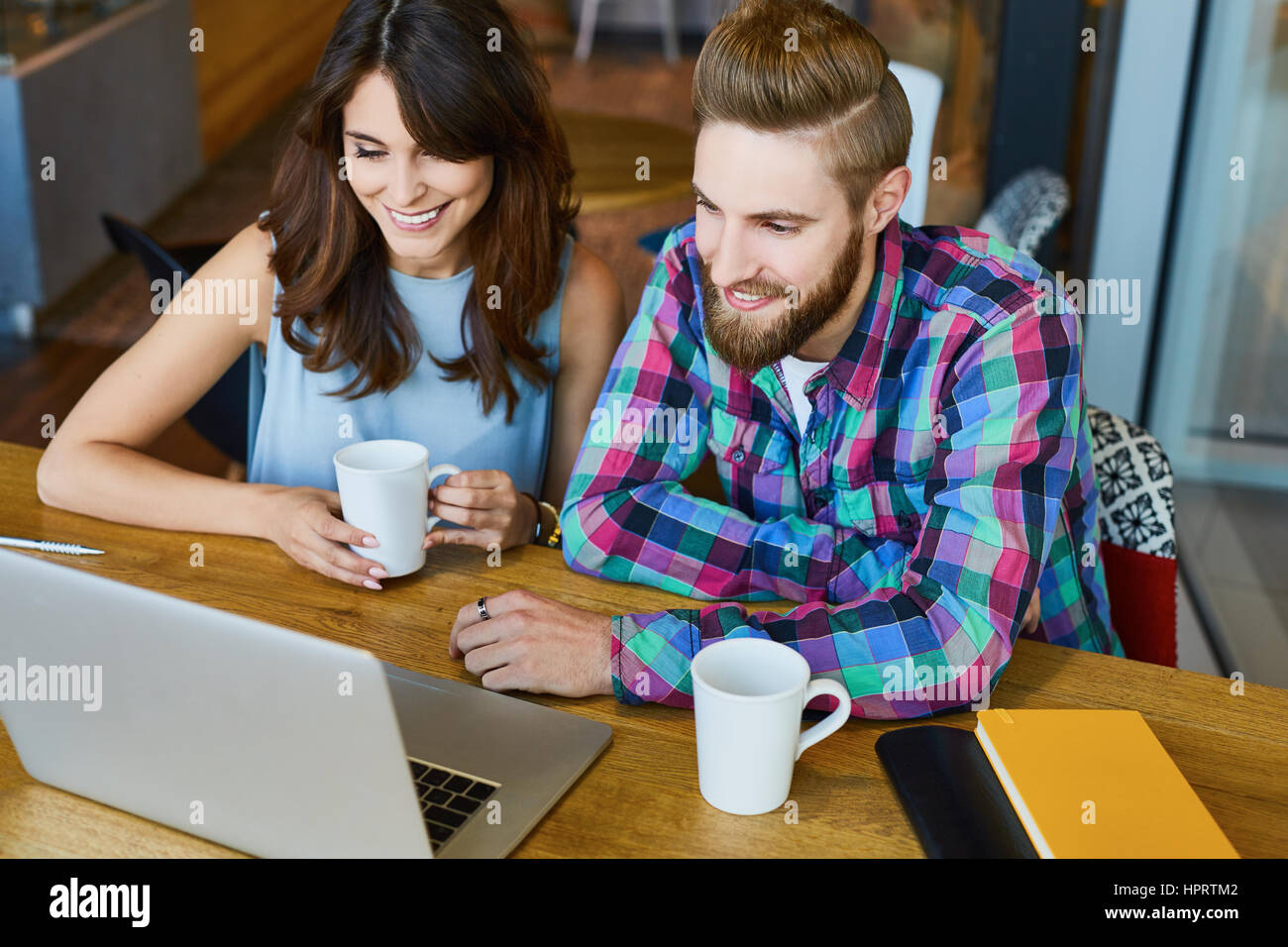 Friends working with laptop on new startup ideas in cafe Stock Photo ...