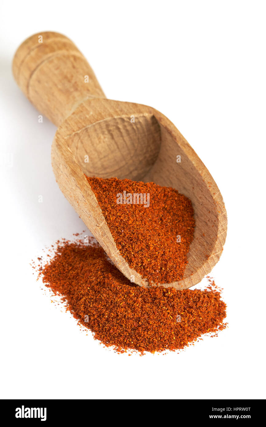 Red paprika powder with wooden scoop isolated on white background Stock ...