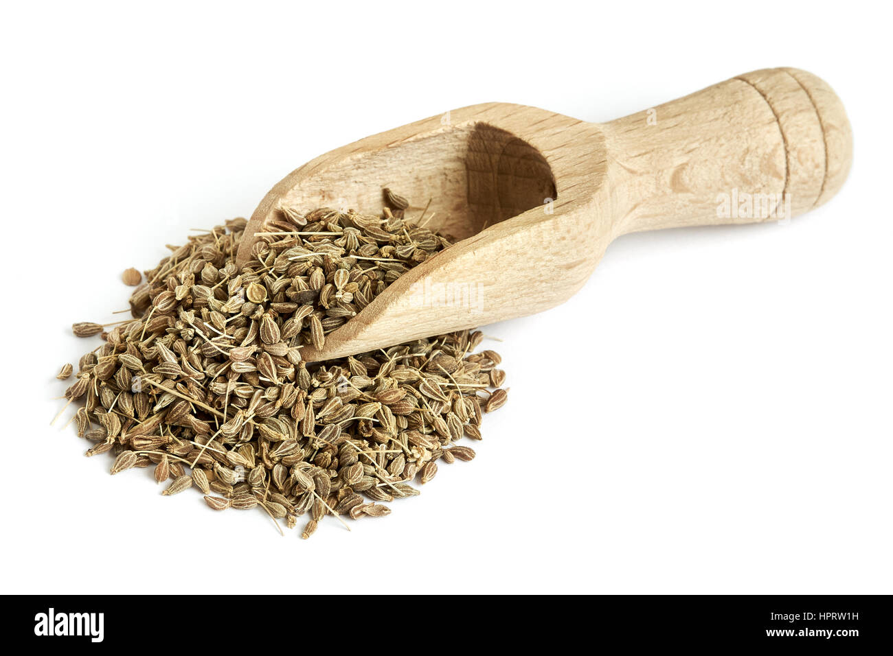 Pile of of dried anise seed (aniseed) with wooden scoop isolated on ...