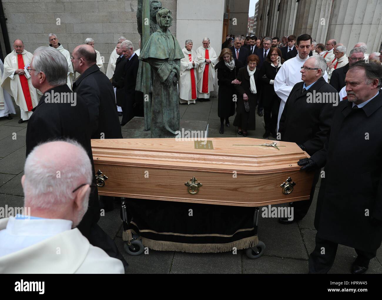 The coffin is brought from the cathedral following the funeral mass of ...
