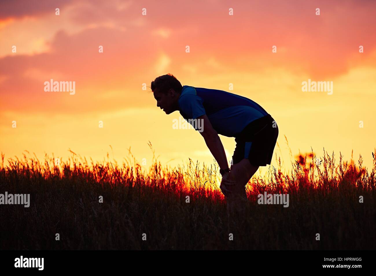 Silhouette of runner. Outdoor cross-country running. Pensive young man ...