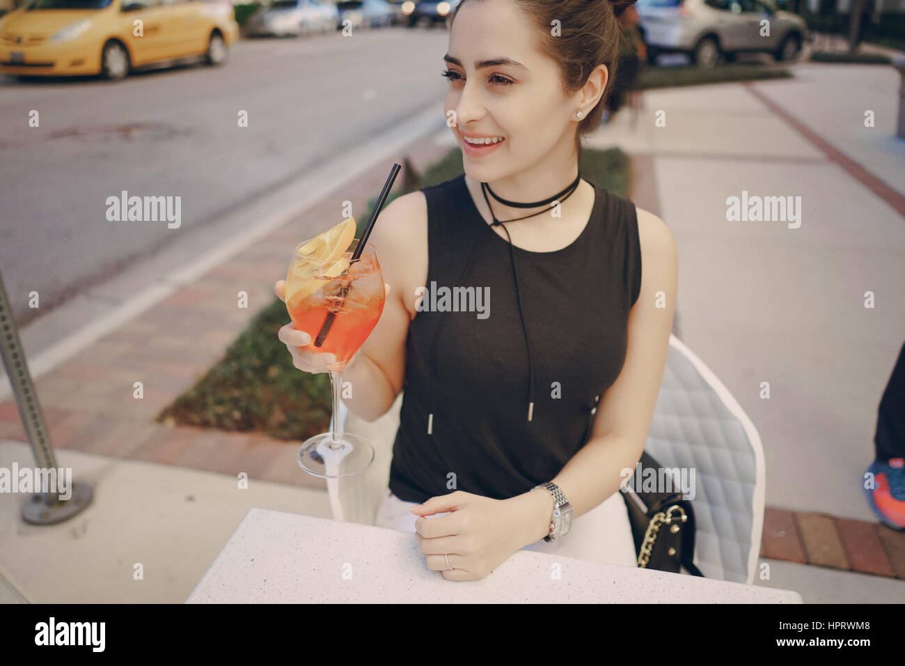 beautiful young girl enjoying a delicious cocktail Stock Photo - Alamy