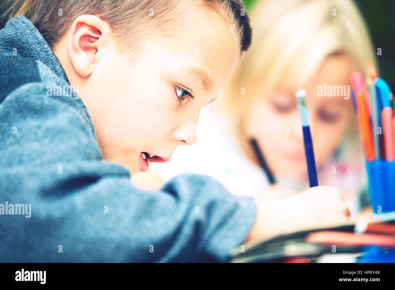 Siblings are doing his homework for elementary school Stock Photo - Alamy