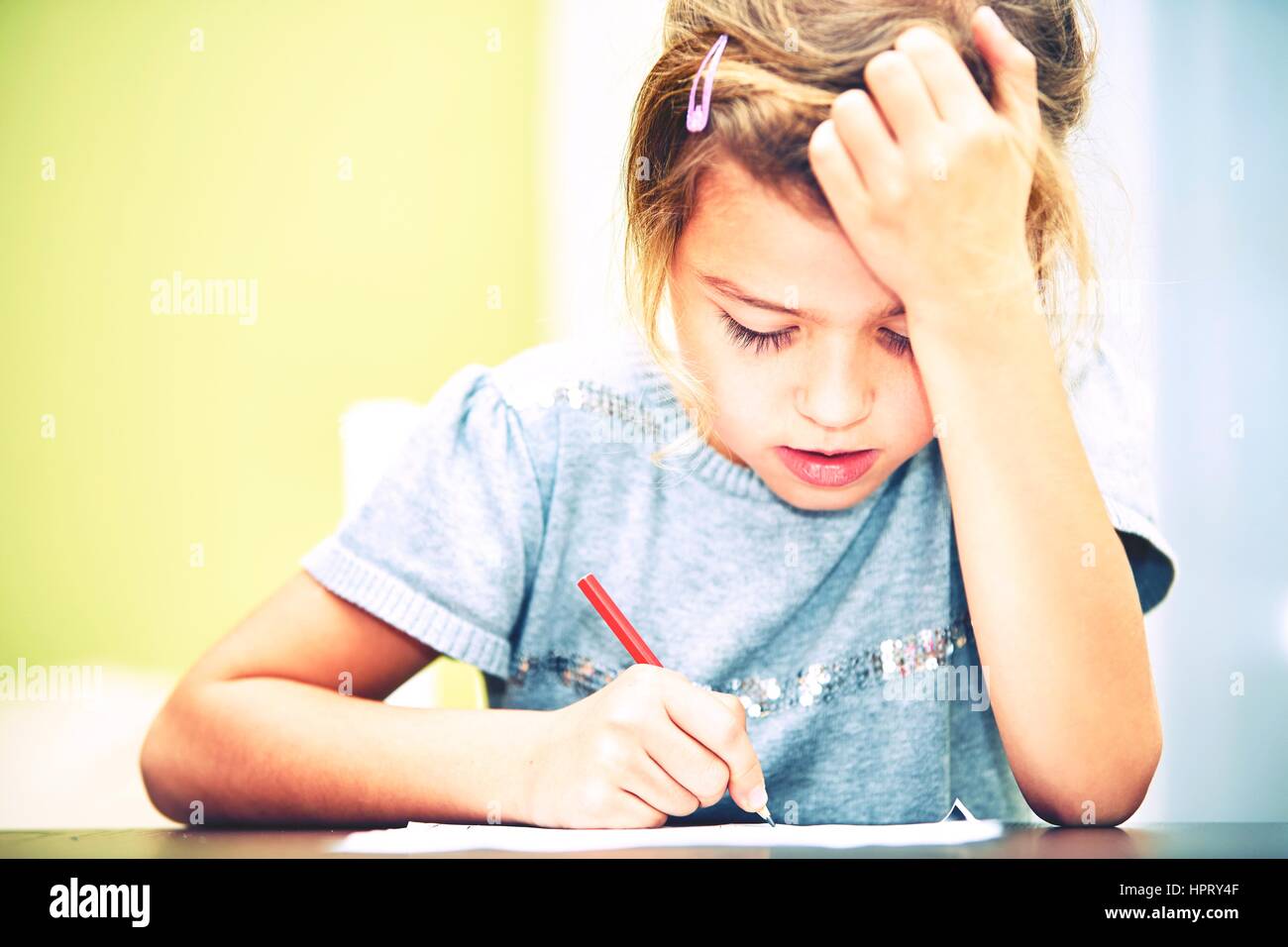 Little girl is doing his homework for elementary school Stock Photo - Alamy