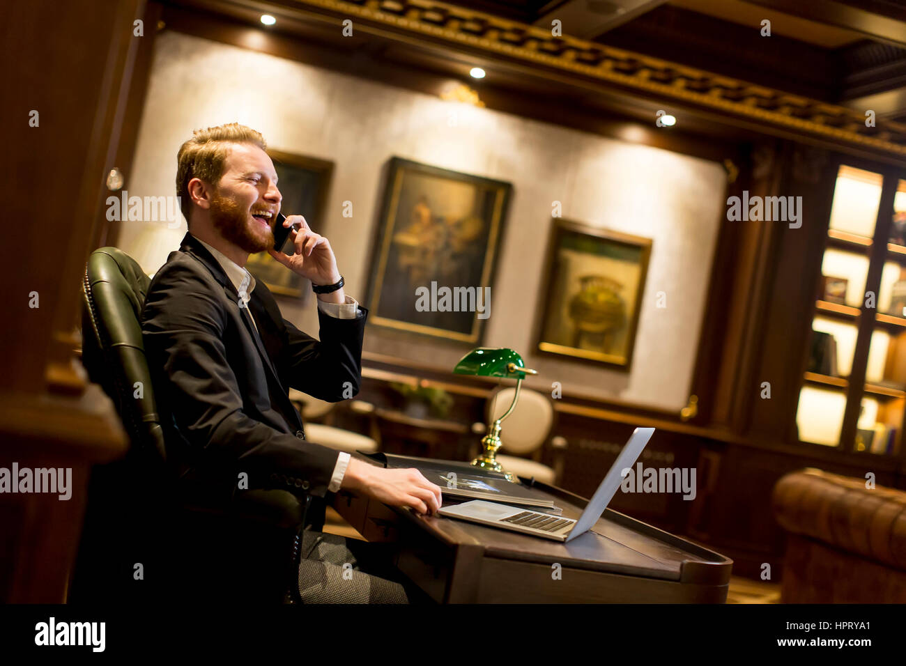 Young man working in the room with vintage furniture Stock Photo - Alamy