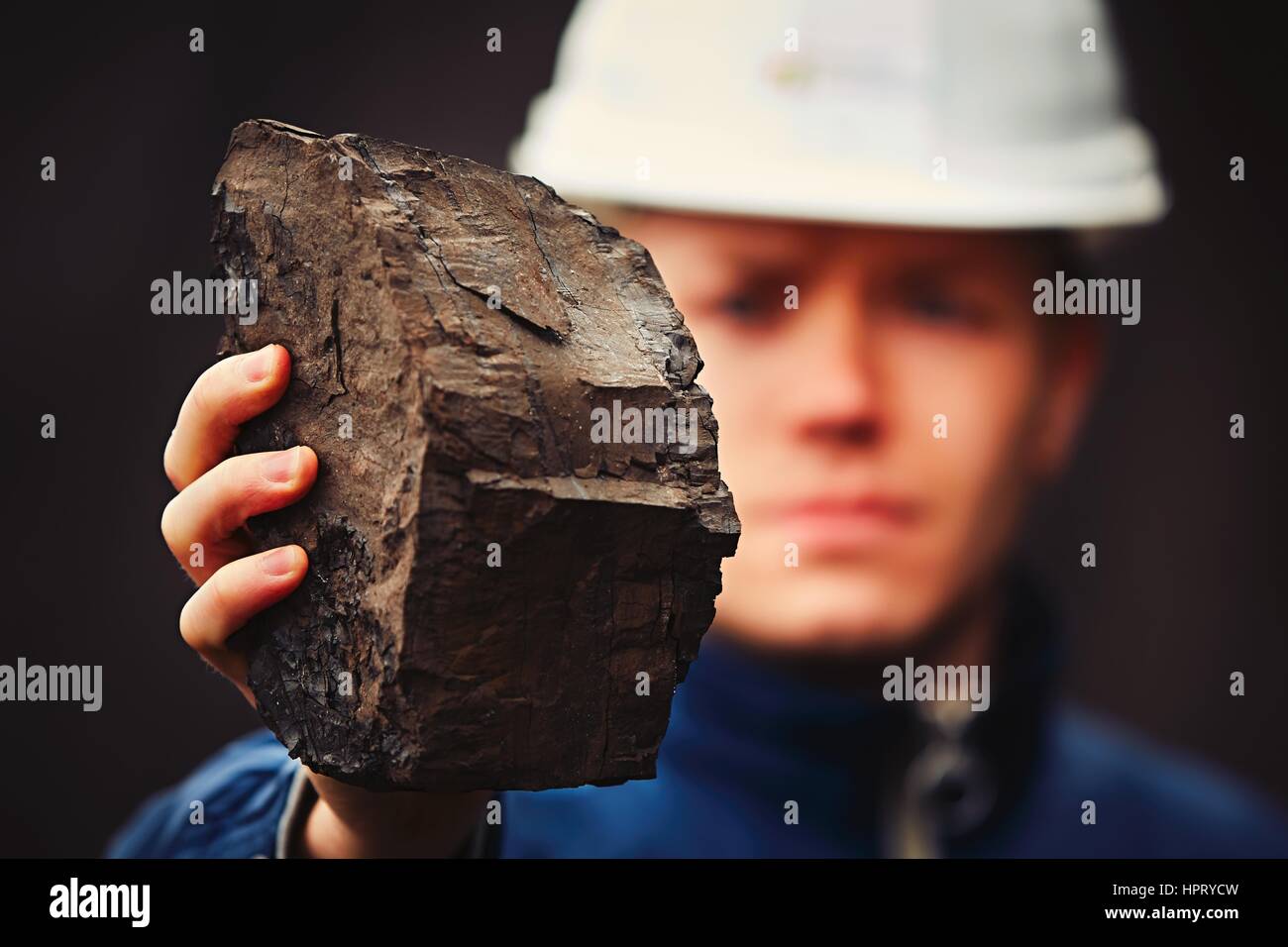 Worker is showing lignite - often referred to as brown coal Stock Photo ...