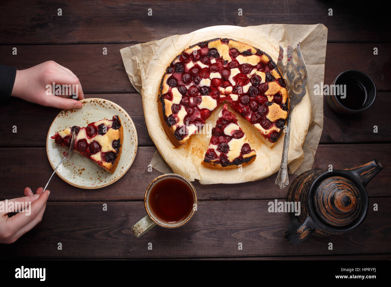 Homemade cherry pie with tea cup on wooden table. Lay flat. Top view ...