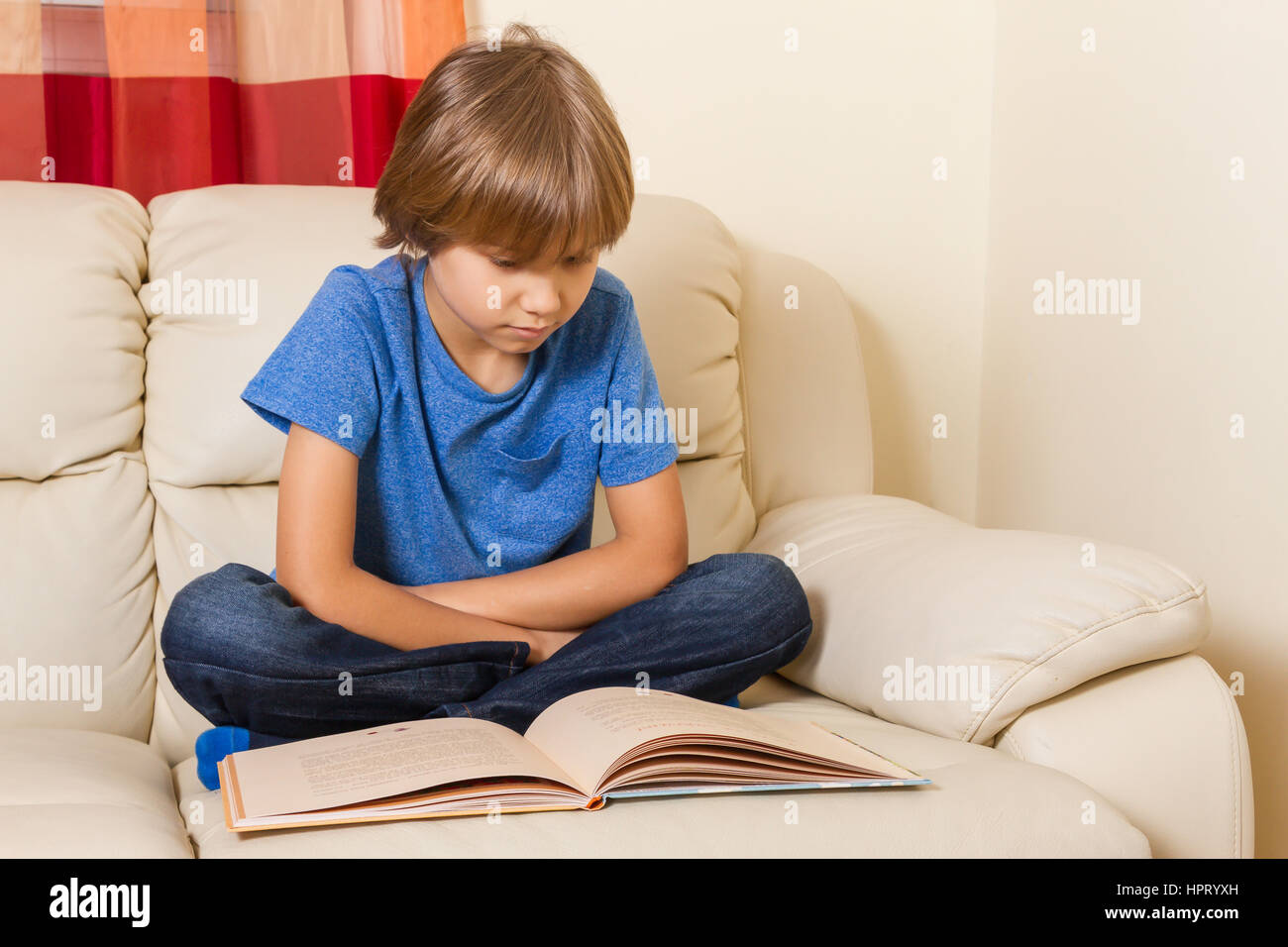 Little kid reading a book at home Stock Photo - Alamy