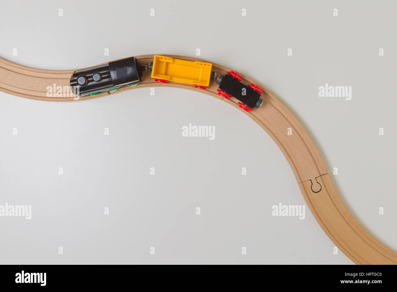 Toy train and wooden rails on white background. Top view Stock Photo ...