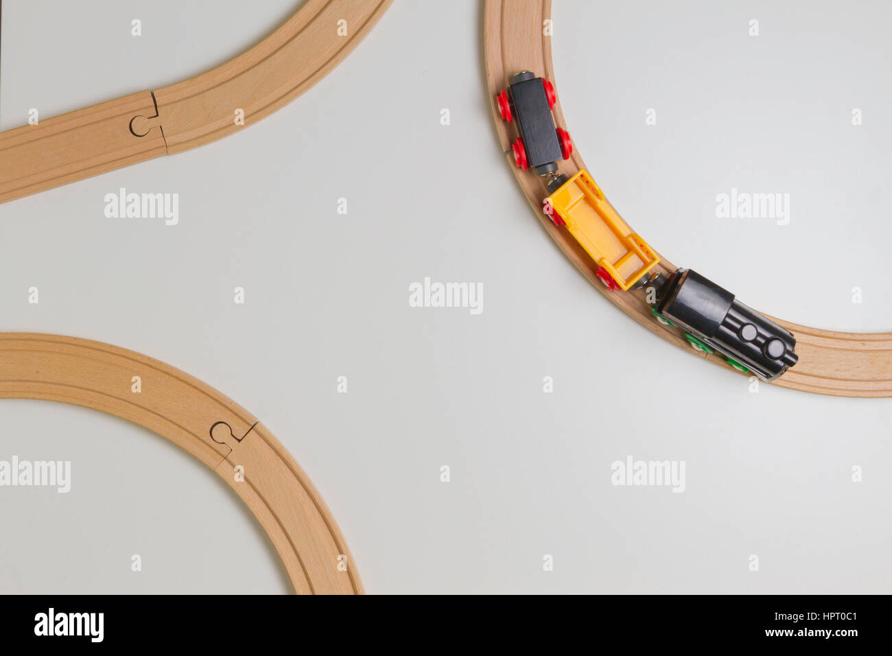 Toy train and wooden rails on white background. Top view Stock Photo ...