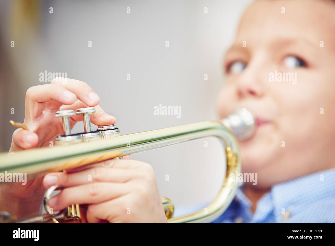Little boy is playing the trumpet at home Stock Photo - Alamy