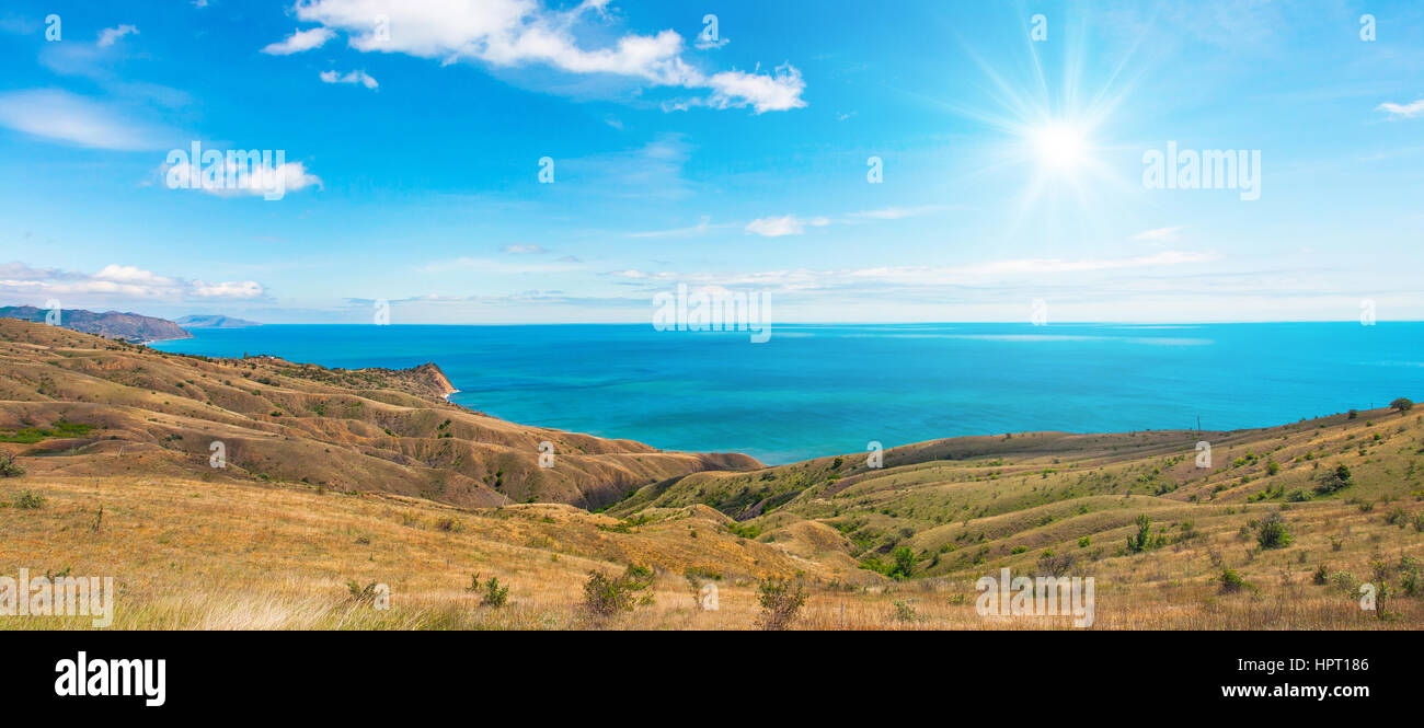 Calm summer day on the seaside with blue sky and sun Stock Photo - Alamy