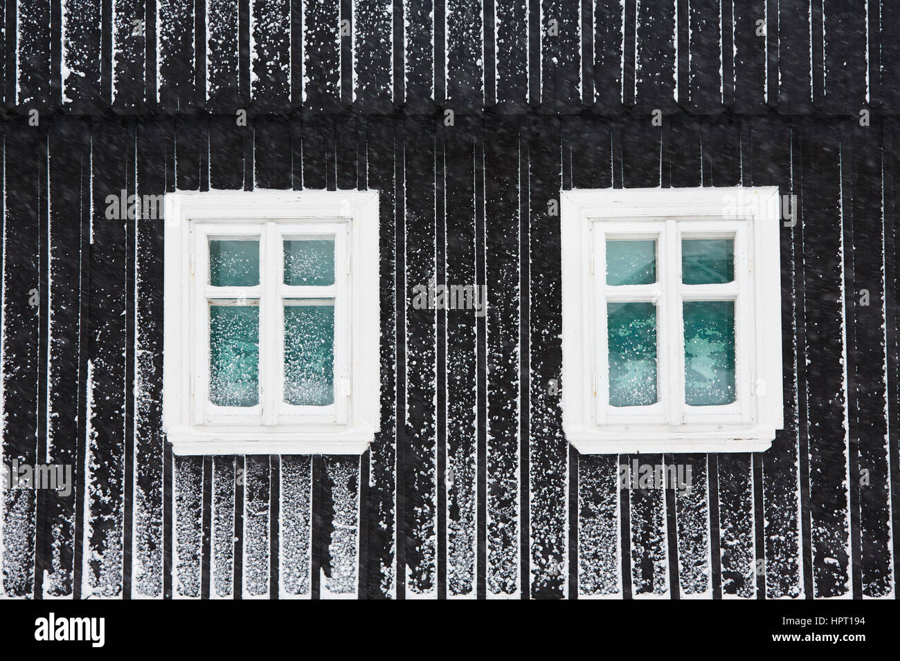 Two windows of the wooden house in winter Stock Photo - Alamy