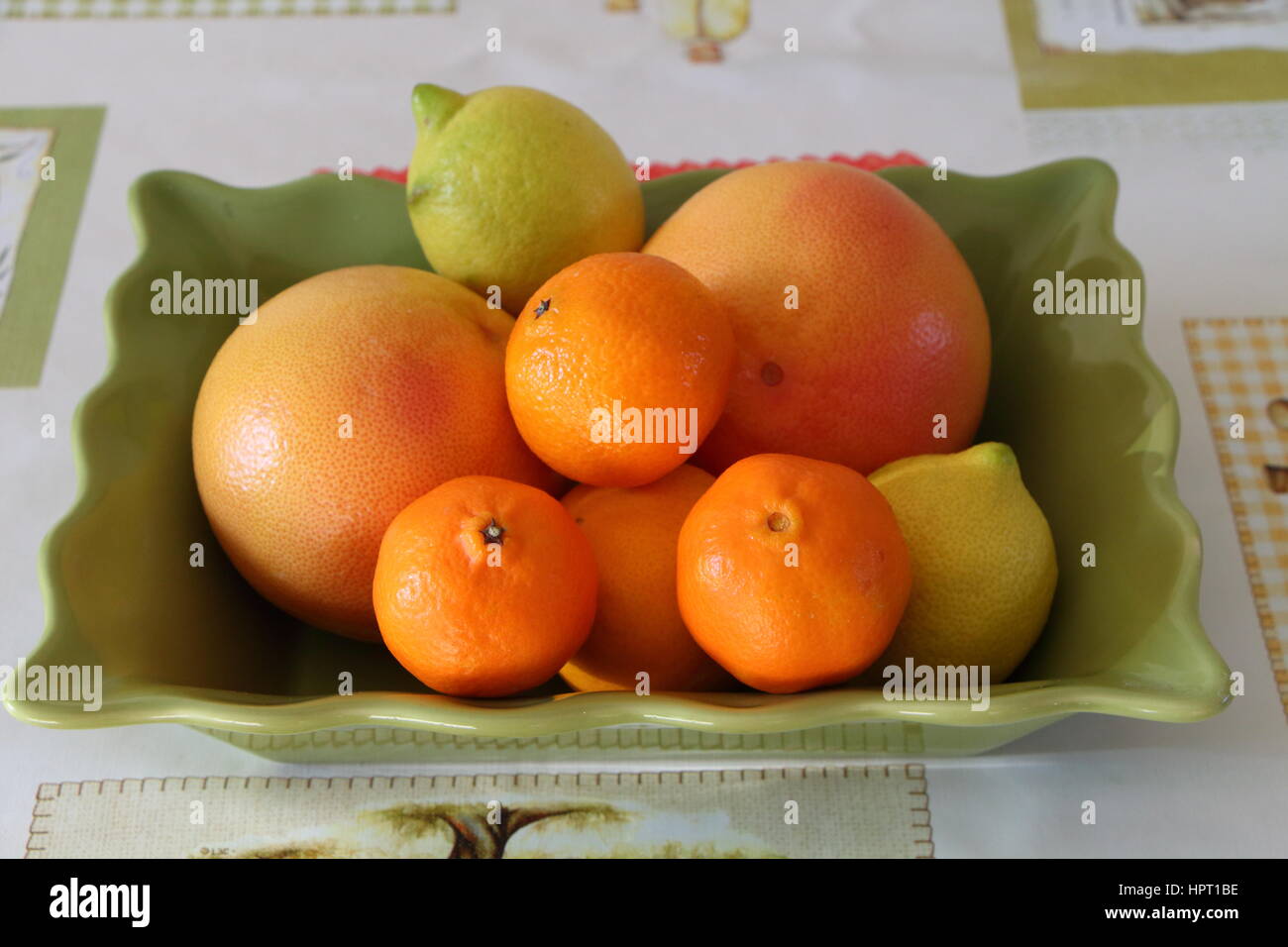 Dish of citrus on a table Stock Photo - Alamy