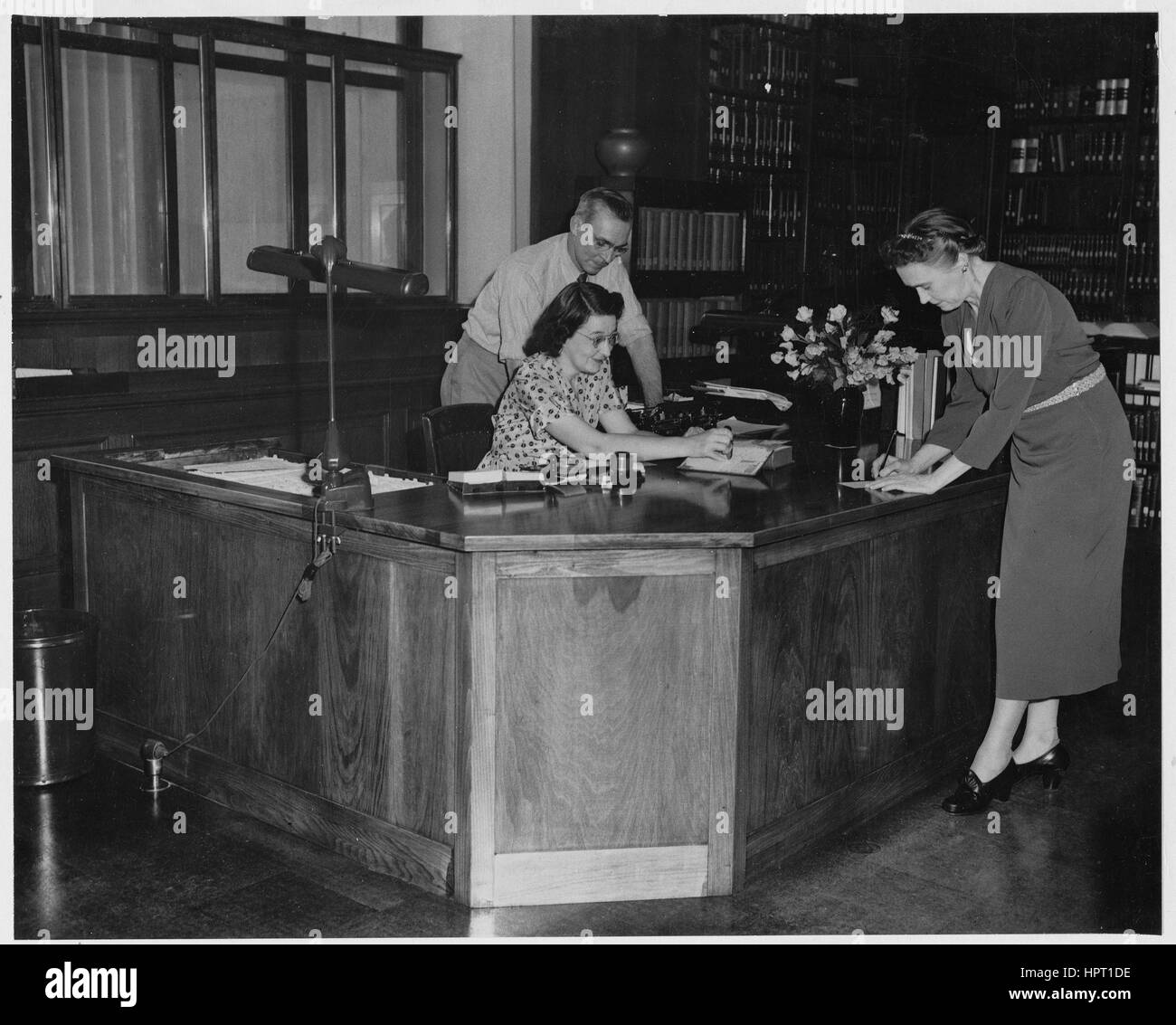 Employees of the National Archives use a desk that was constructed in ...