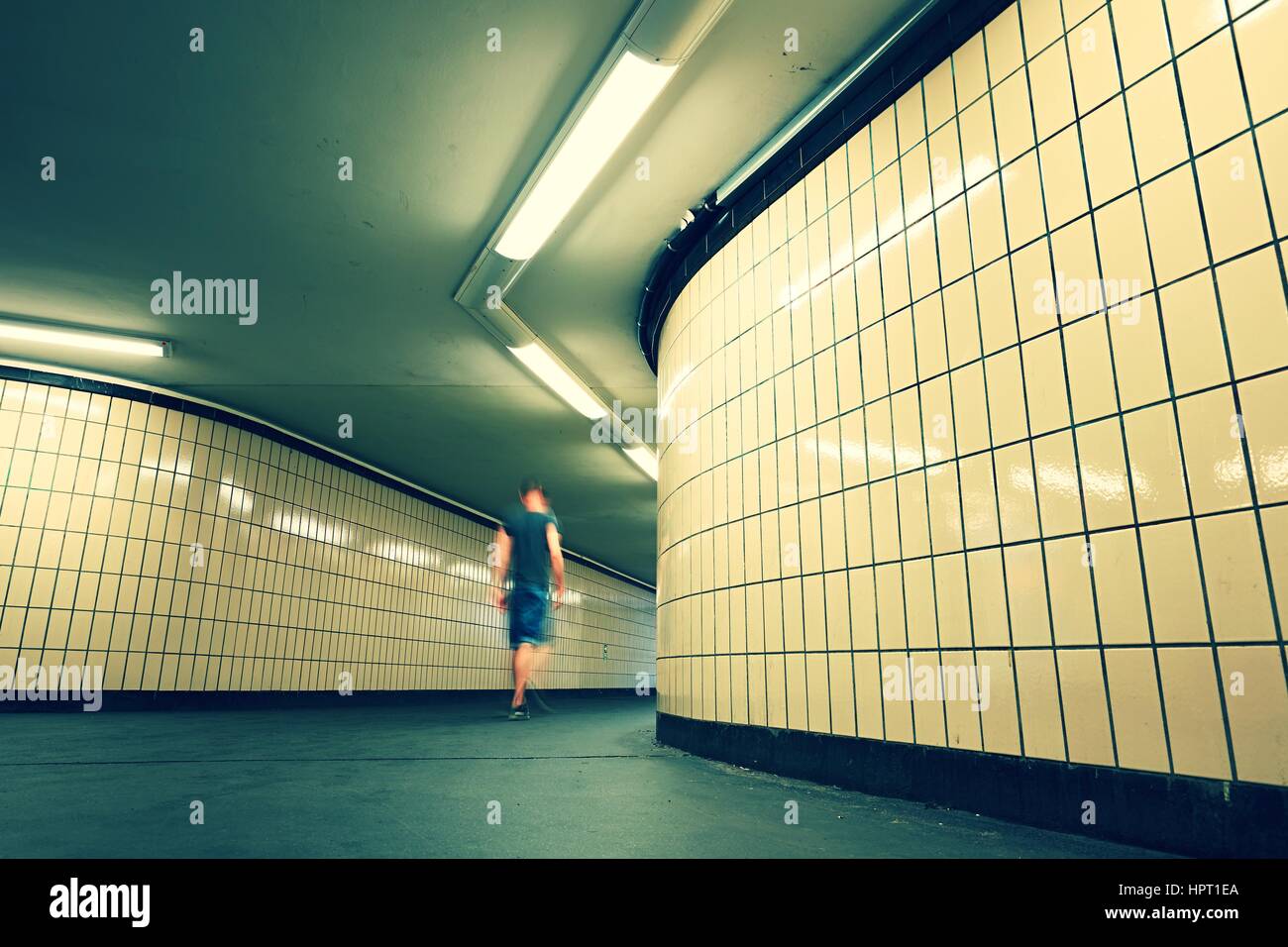 Pedestrian is walking in underground passage from subway. Alone young ...