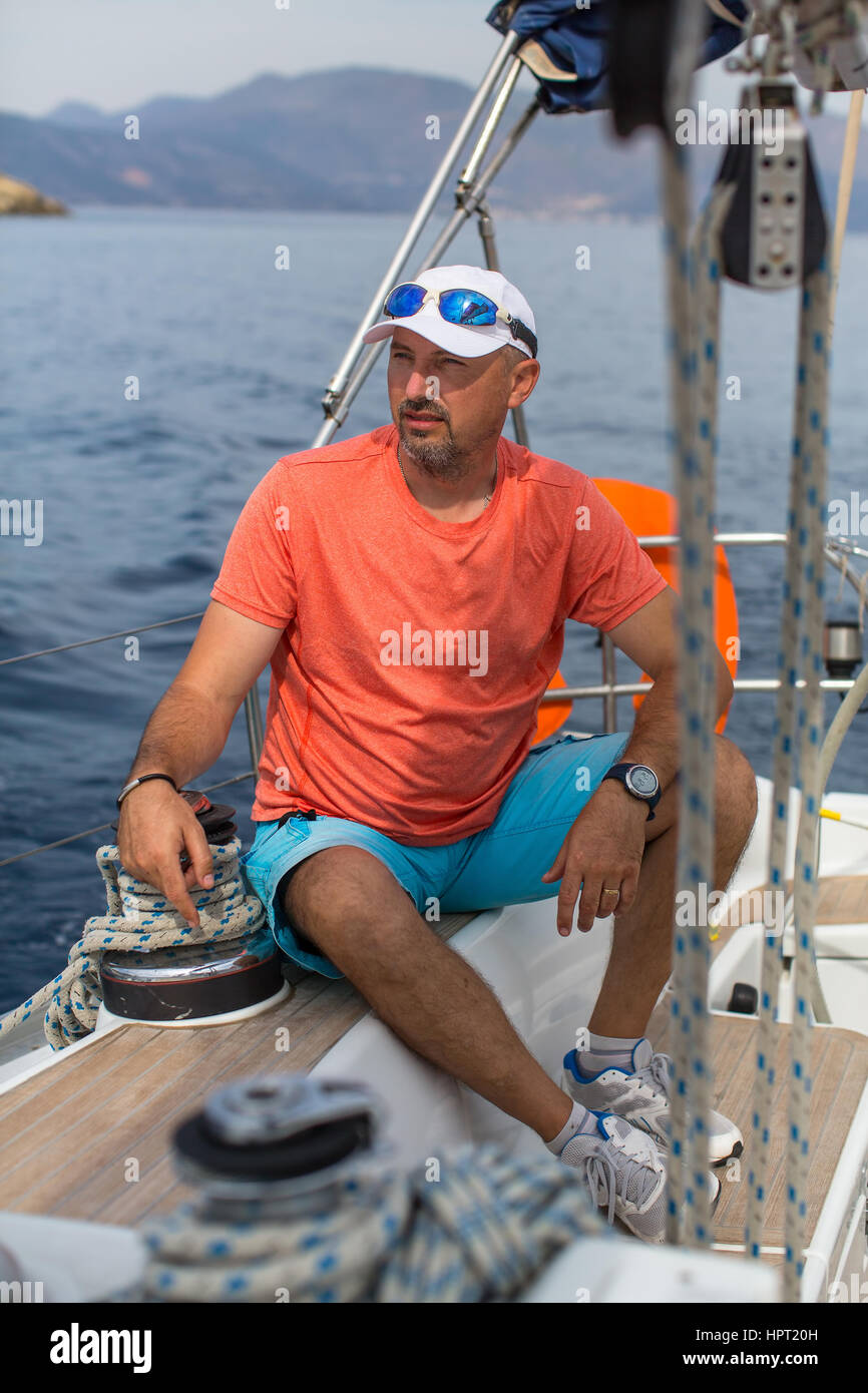 Man on his sailing yacht boat Stock Photo - Alamy