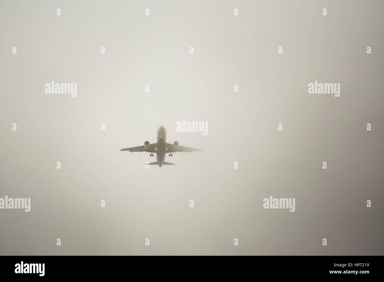 The airplane is landing during bad weather in thick fog Stock Photo - Alamy