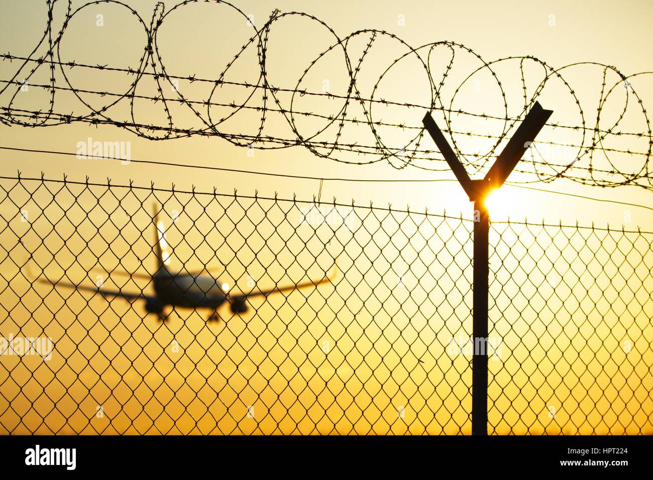 Airport at the sunset - security system Stock Photo - Alamy