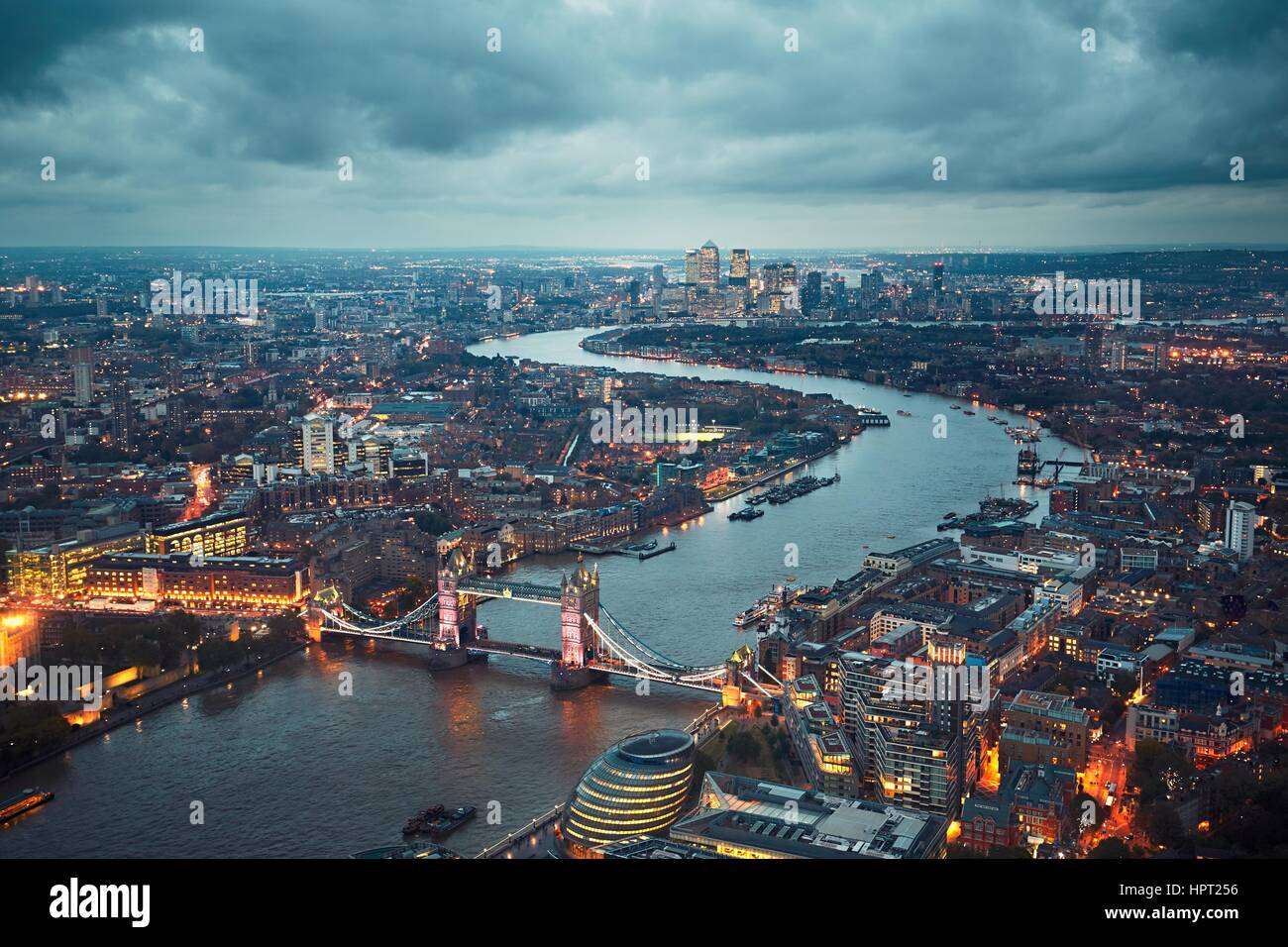 London skyline with illuminated Tower bridge and Canary Wharf at the ...