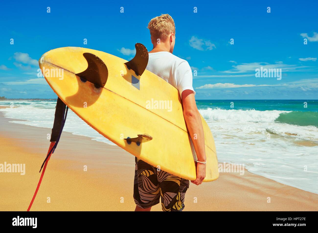 Man with surfboard on the beach at sunset Stock Photo - Alamy