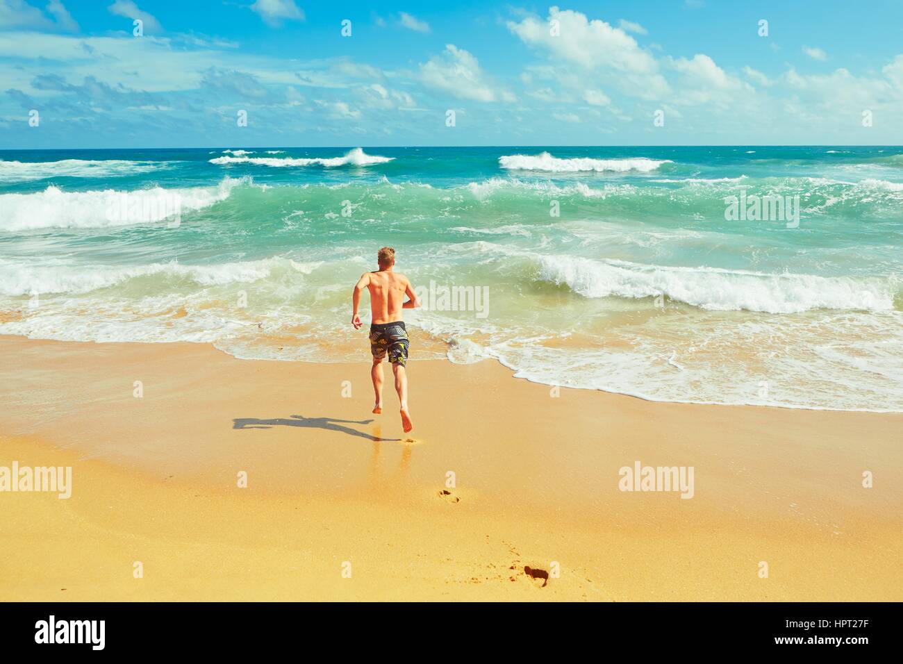 Man running beach handsome hi-res stock photography and images - Alamy