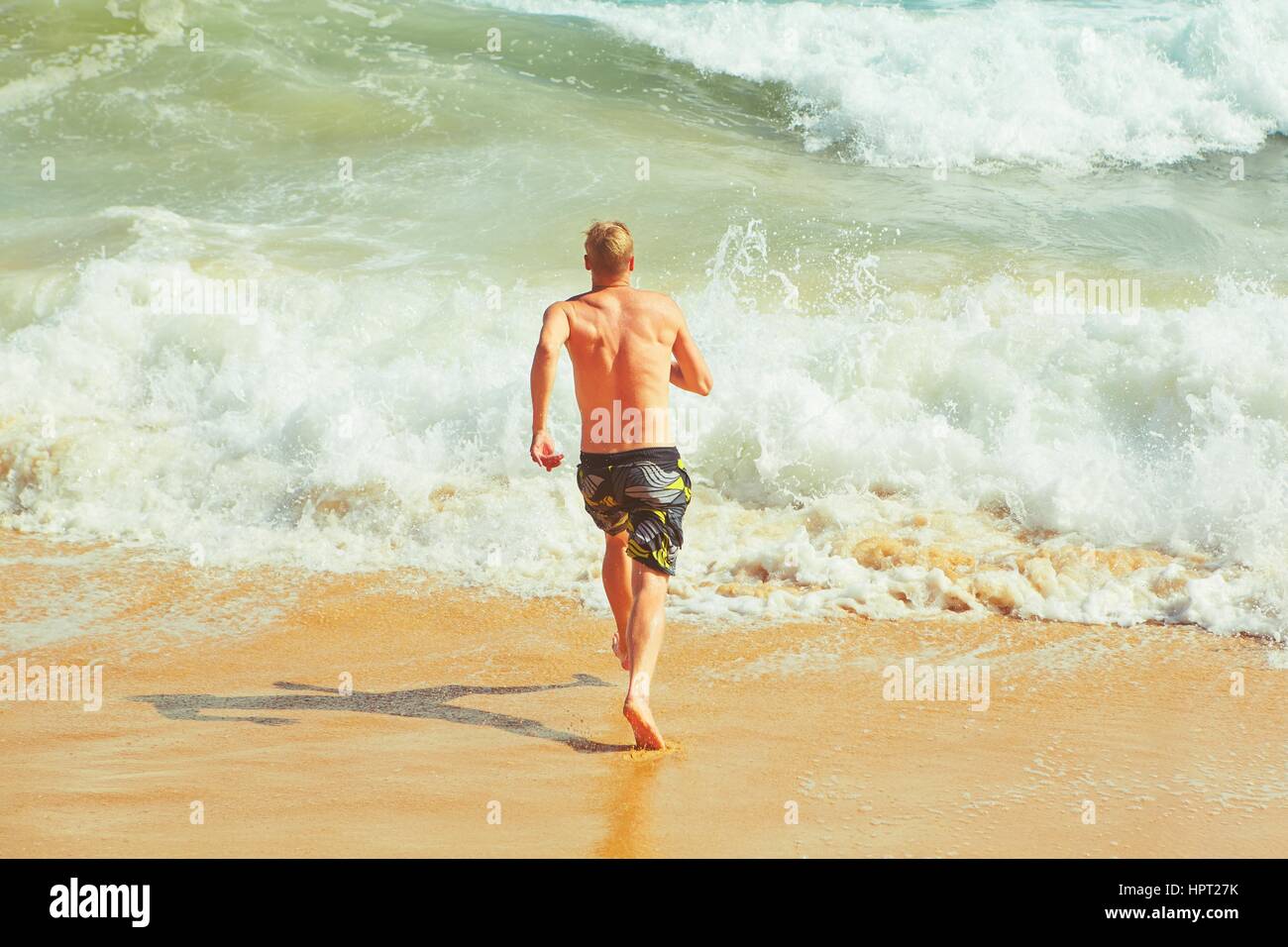Running into the sea hi-res stock photography and images - Alamy