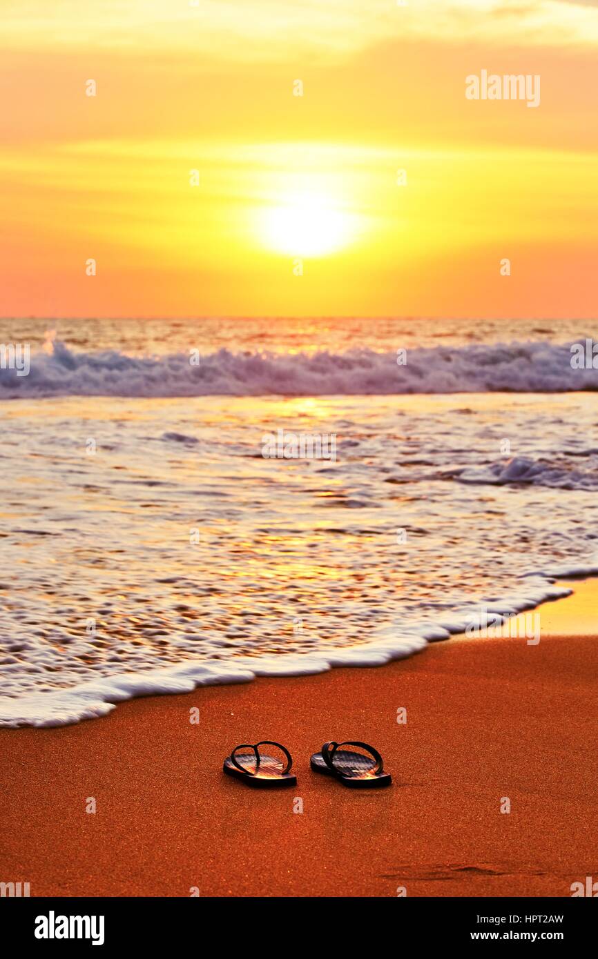 Flip flops on the beach at sunset Stock Photo - Alamy