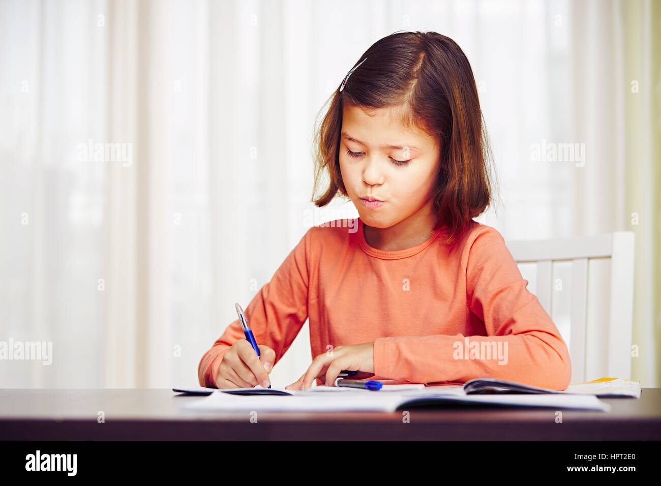 Little girl is doing his homework for elementary school Stock Photo - Alamy