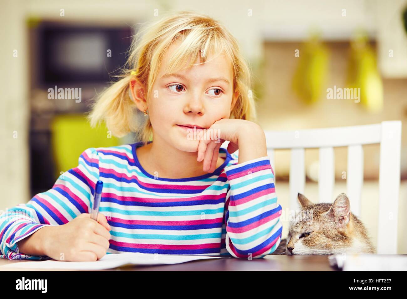 Little girl is doing his homework for elementary school Stock Photo - Alamy