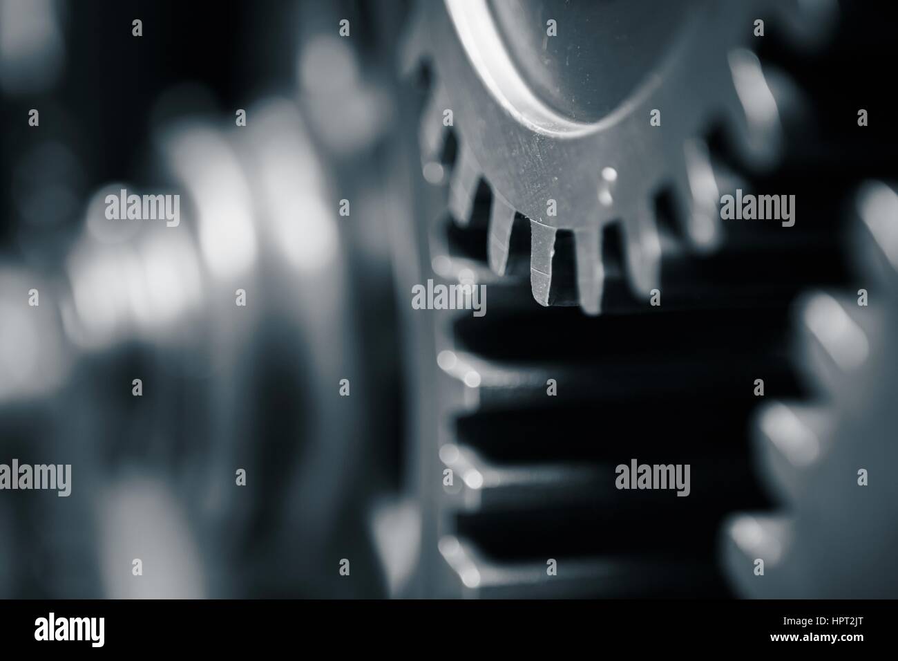 Large cog wheels in the motor - blue toned Stock Photo - Alamy