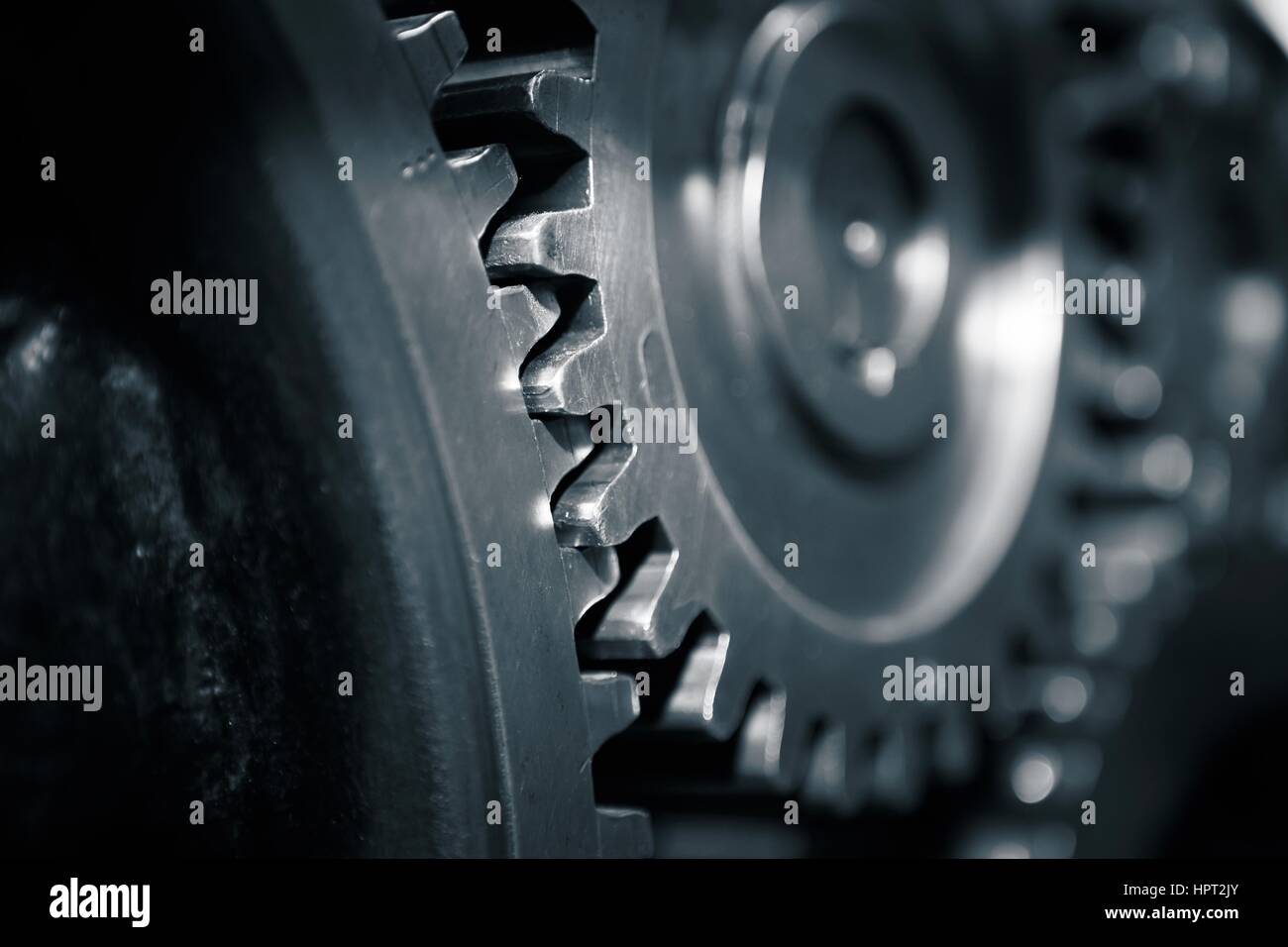 Large cog wheels in the motor - blue toned Stock Photo - Alamy