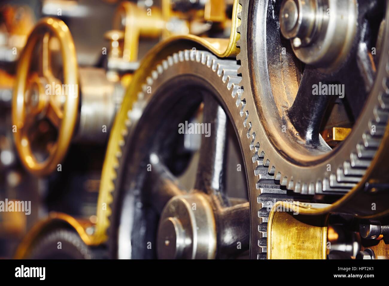 Large cog wheels in the motor - selective focus Stock Photo - Alamy