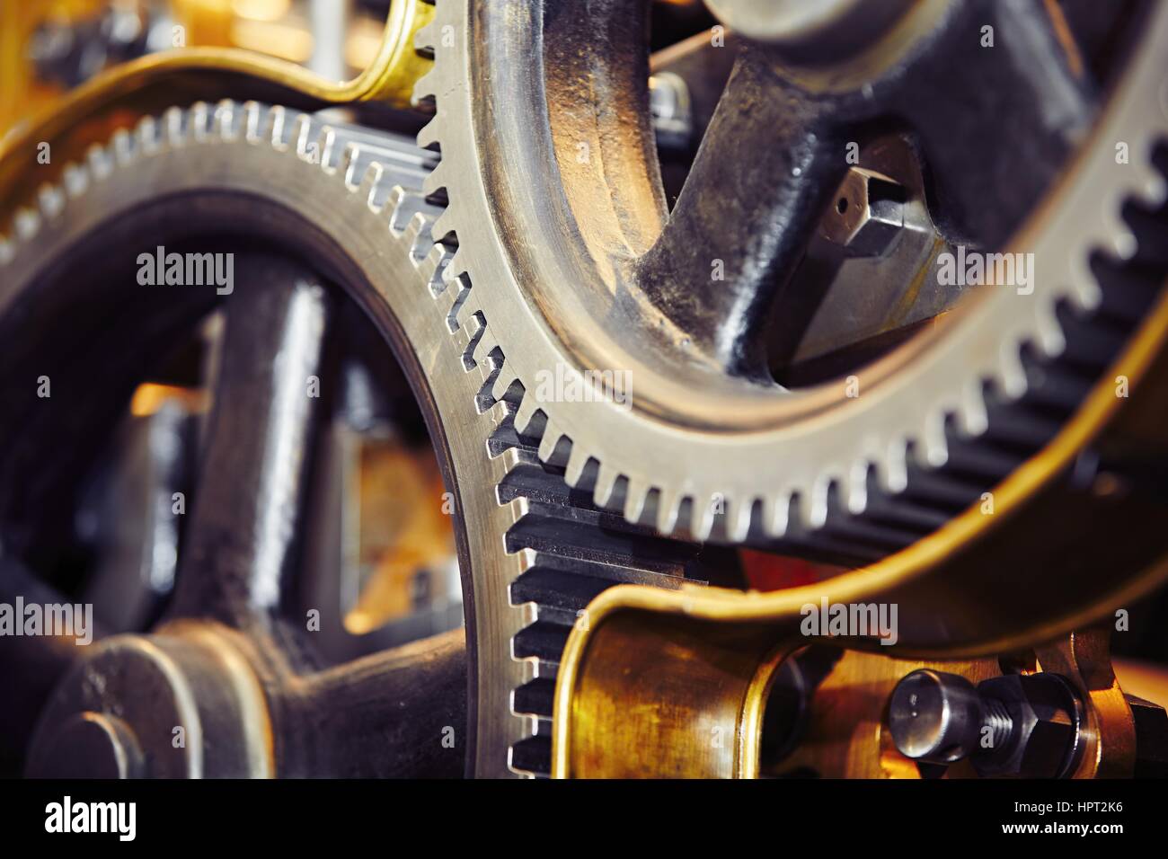 Large cog wheels in the motor - selective focus Stock Photo - Alamy