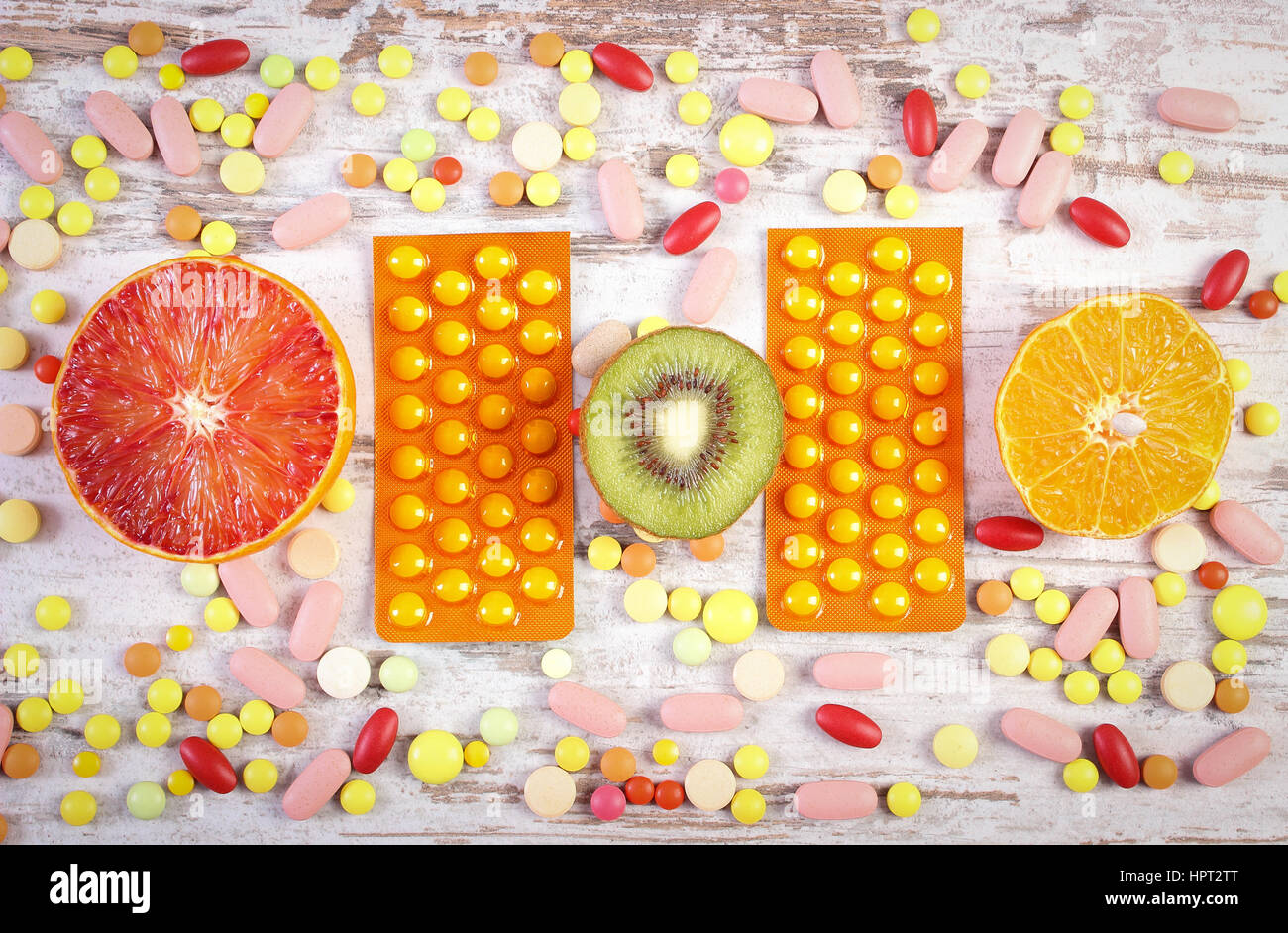 Fresh natural fruits and pills, tablets or capsules, choice between ...