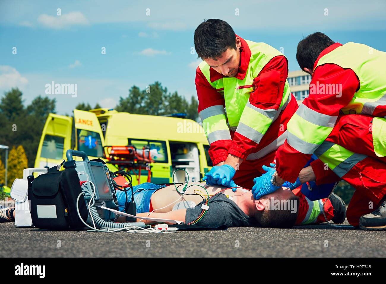 Cardiopulmonary resuscitation. Rescue team (doctor and a paramedic) resuscitating the man on the ...