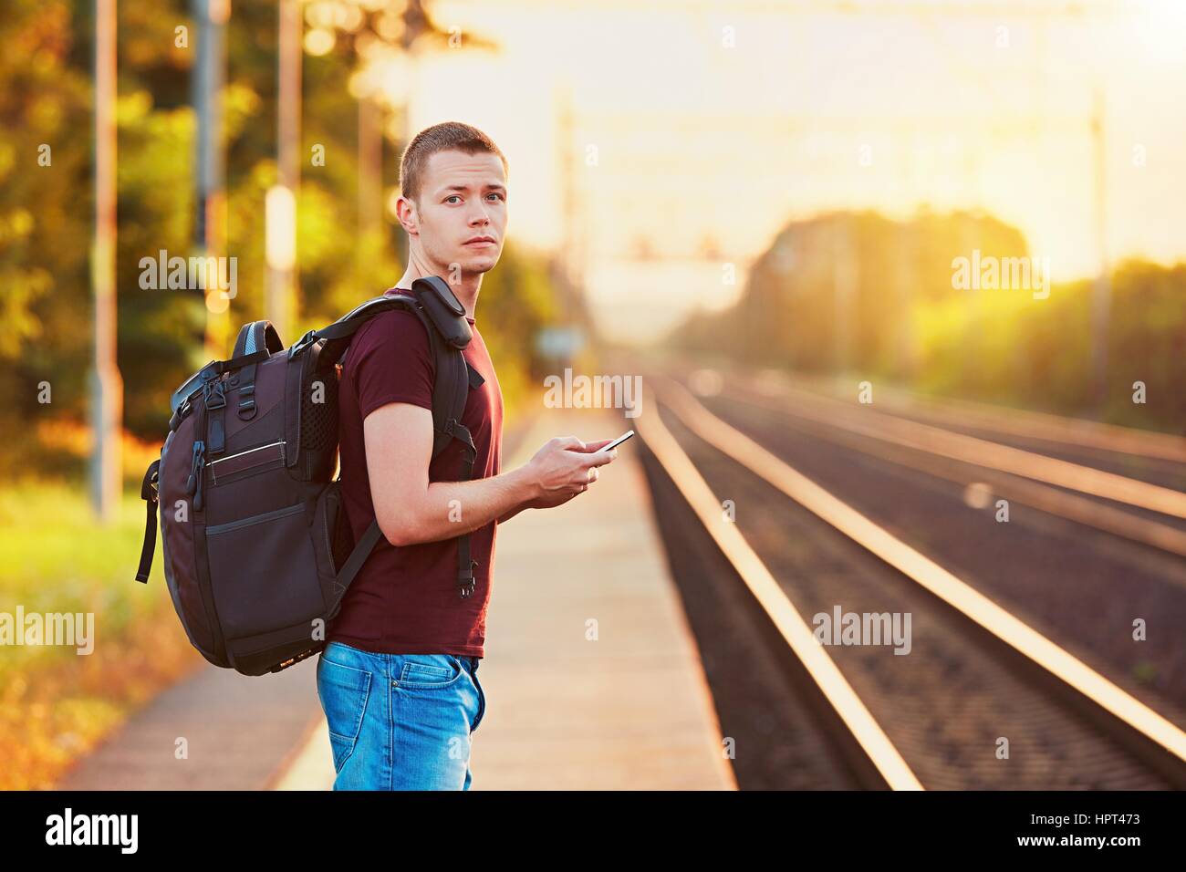 Traveler is late at the train station. Young man with backpack missed ...