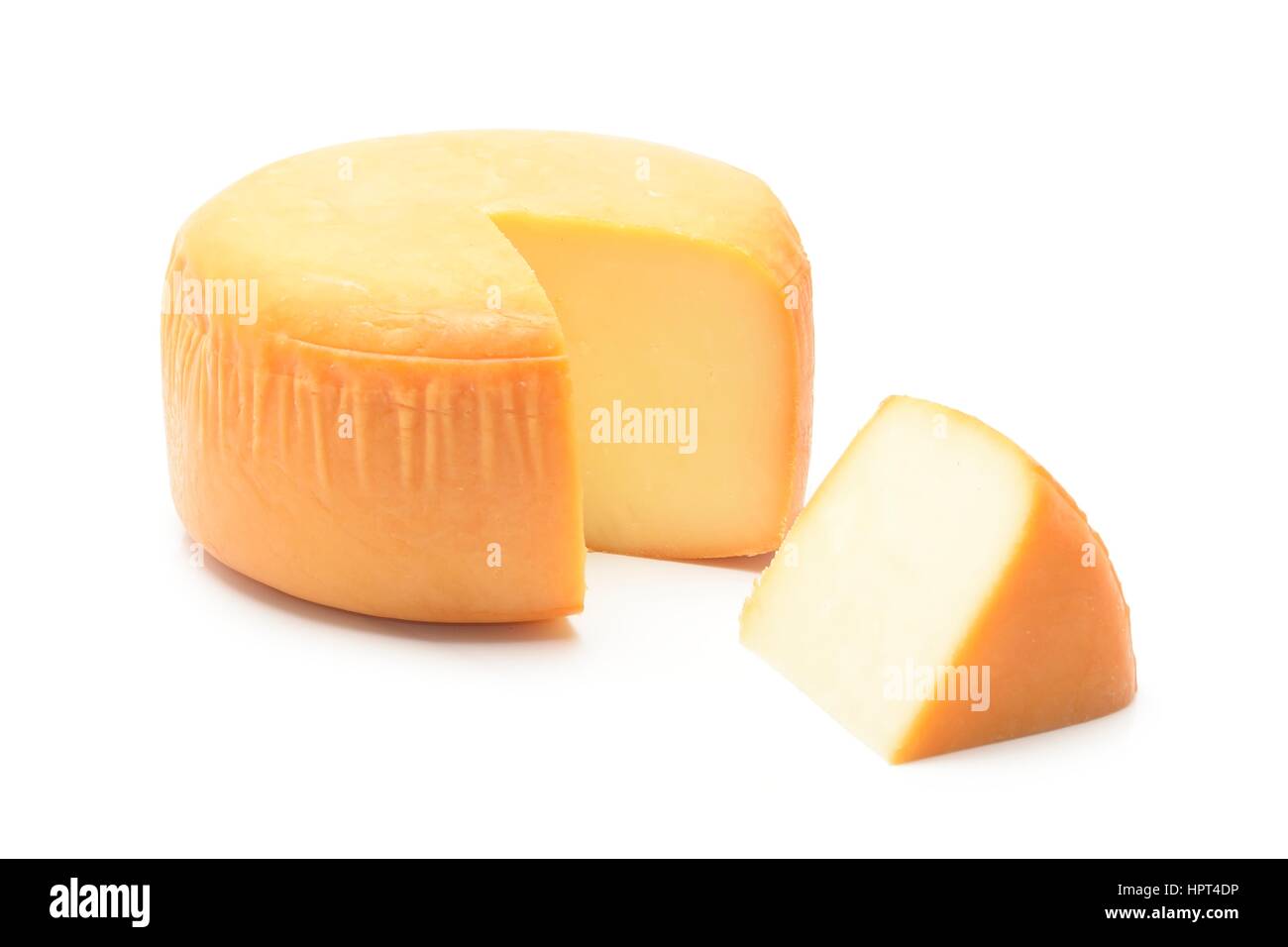 Cheese wheel with a piece of cheese on a white background Stock Photo ...