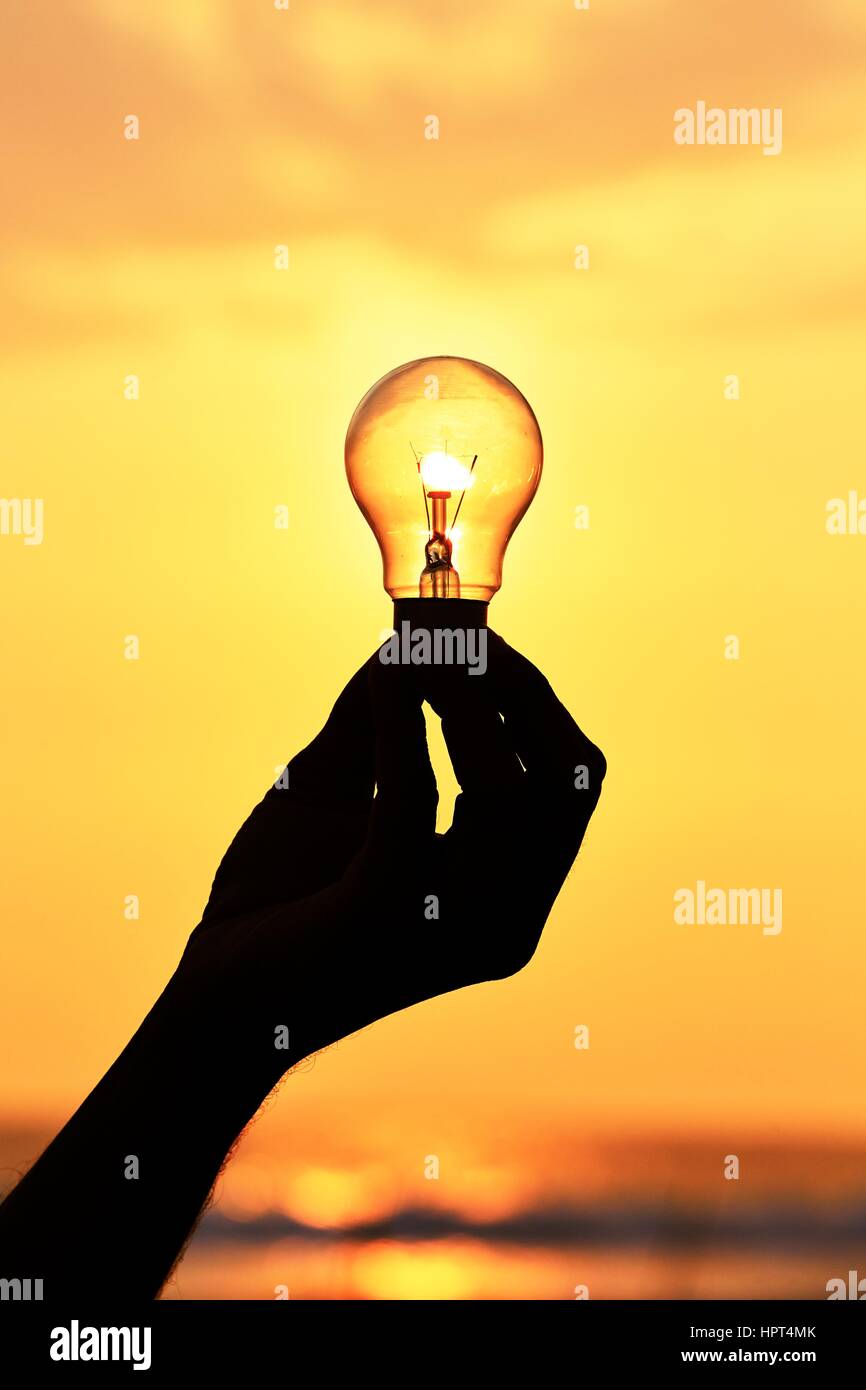 Human hand holding light bulb hi-res stock photography and images - Alamy